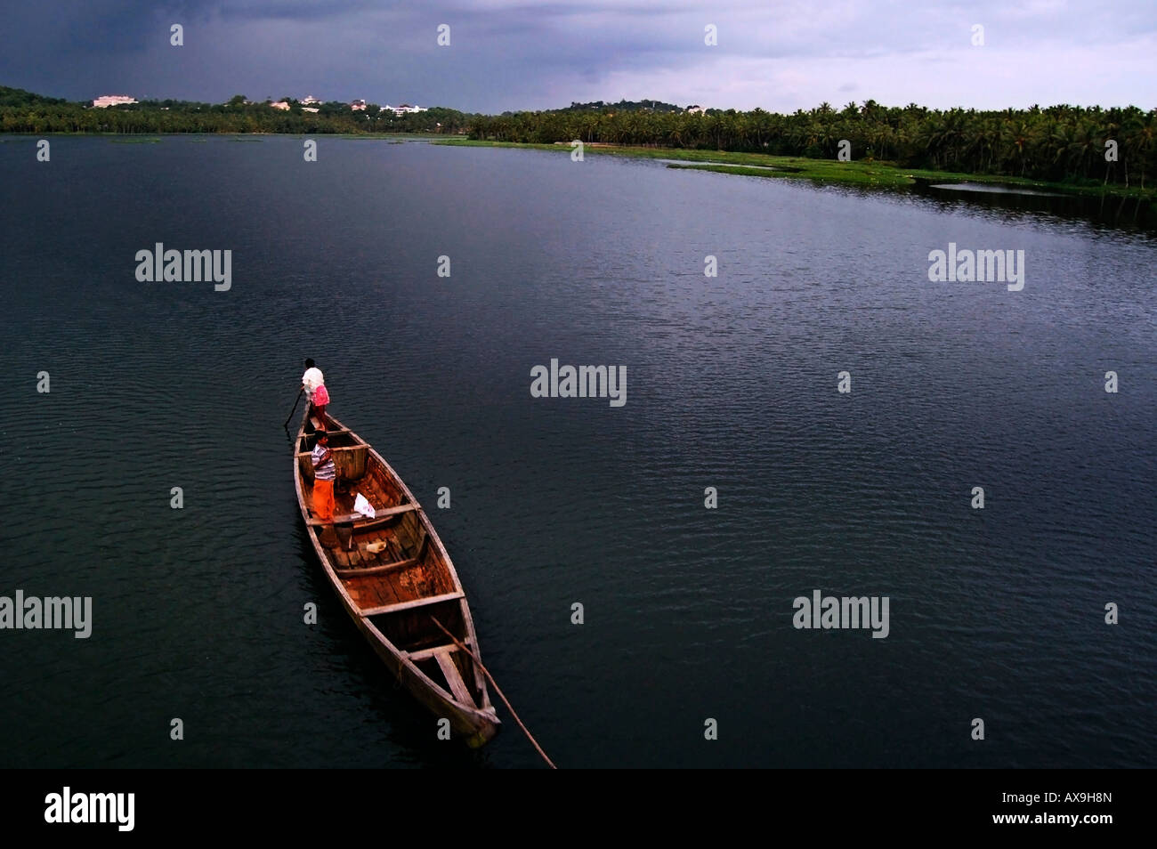 A solitary fishing Boat and fishermen in Akkulam lake Stock Photo - Alamy