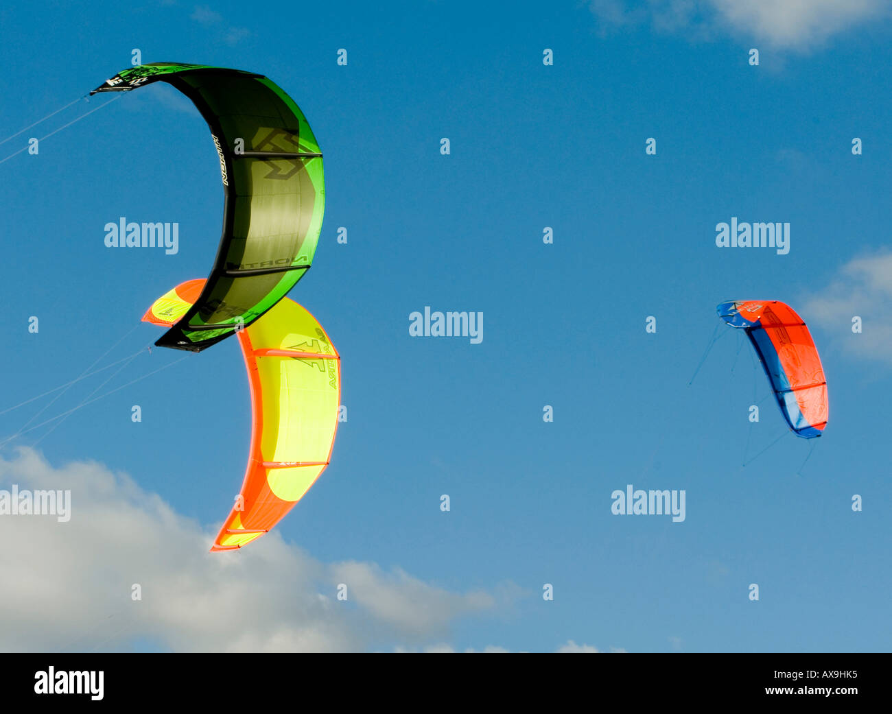 three Kites surfers kites in the sky Stock Photo - Alamy