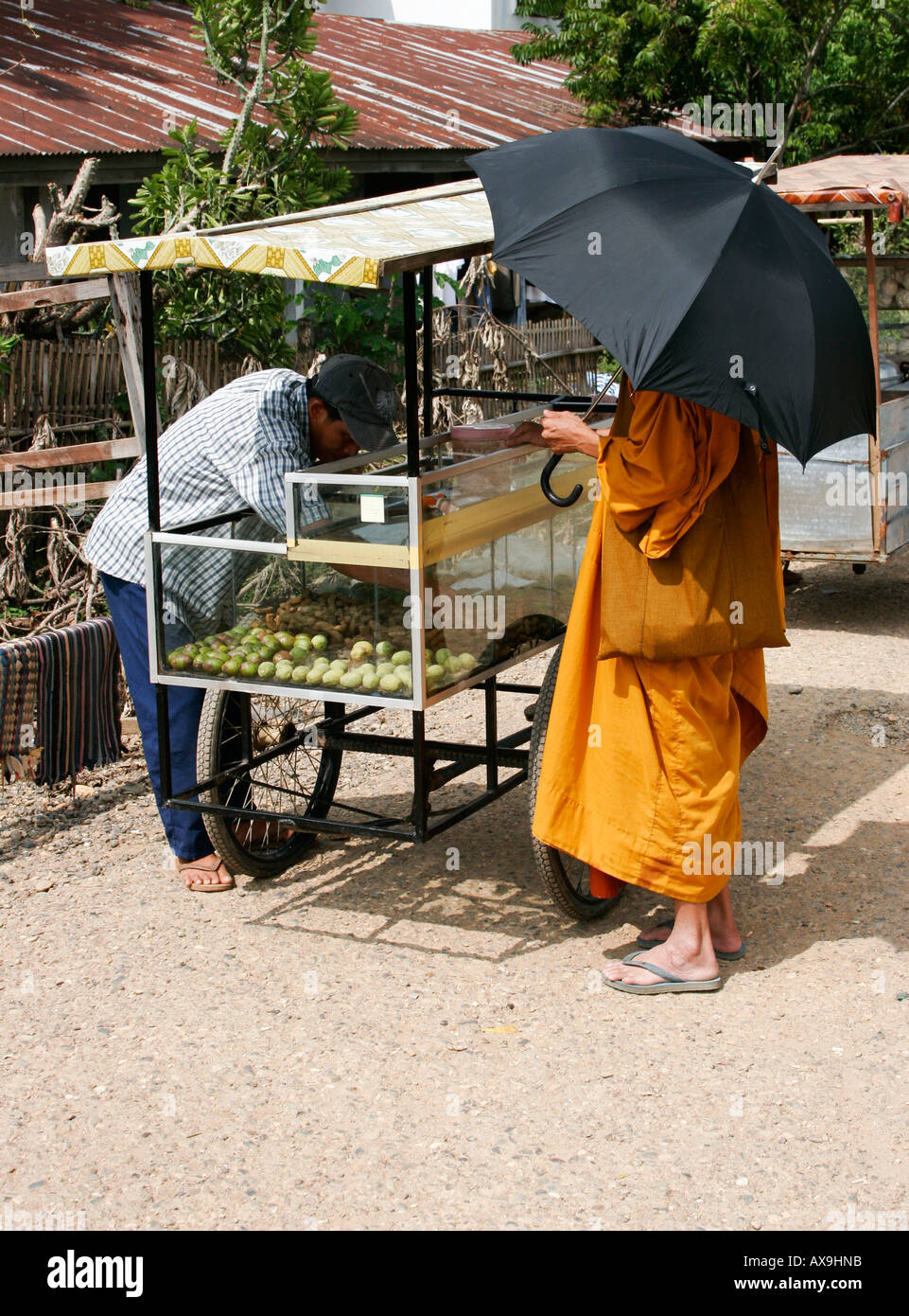 Buddhist monk at market stall Stock Photo - Alamy