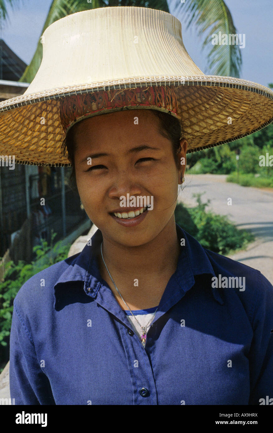 A happy young woman in Bangkok wearing traditional Thai hat, or ngob ...