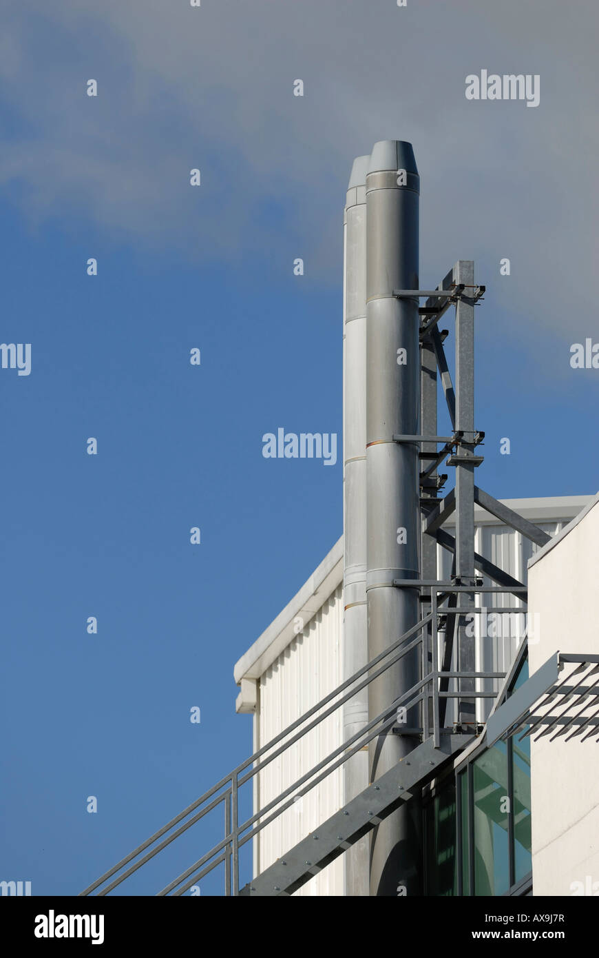 Chimney stacks on a modern industrial building Stock Photo - Alamy