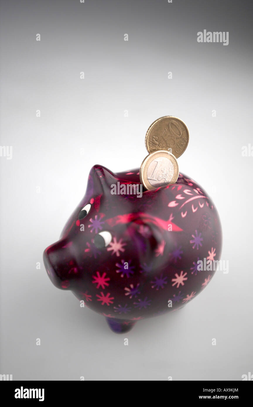 EURO COINS FALLING INTO A PIGGY BANK Stock Photo - Alamy