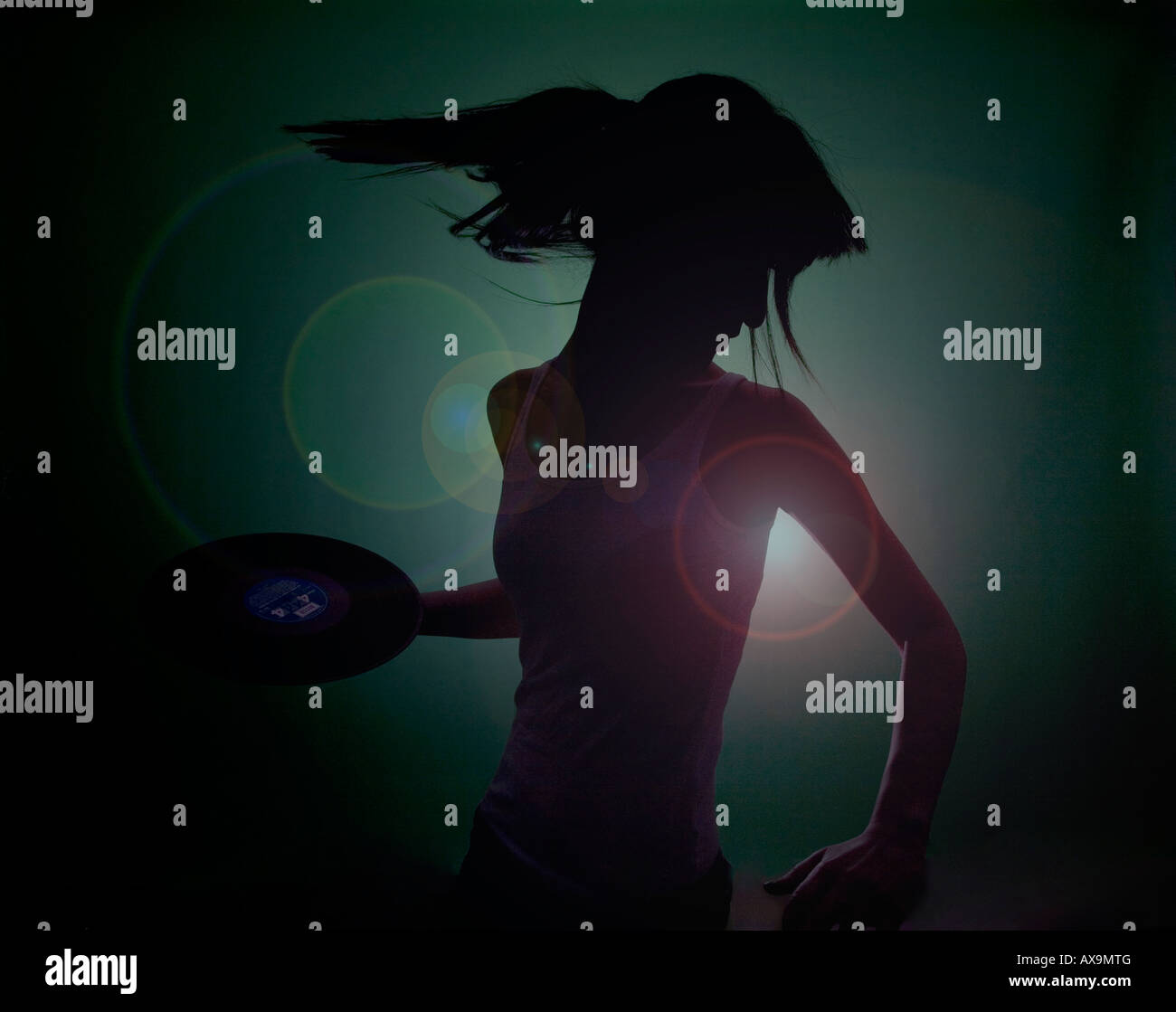 silhouette of a girl dancing whilst holding a record Stock Photo - Alamy