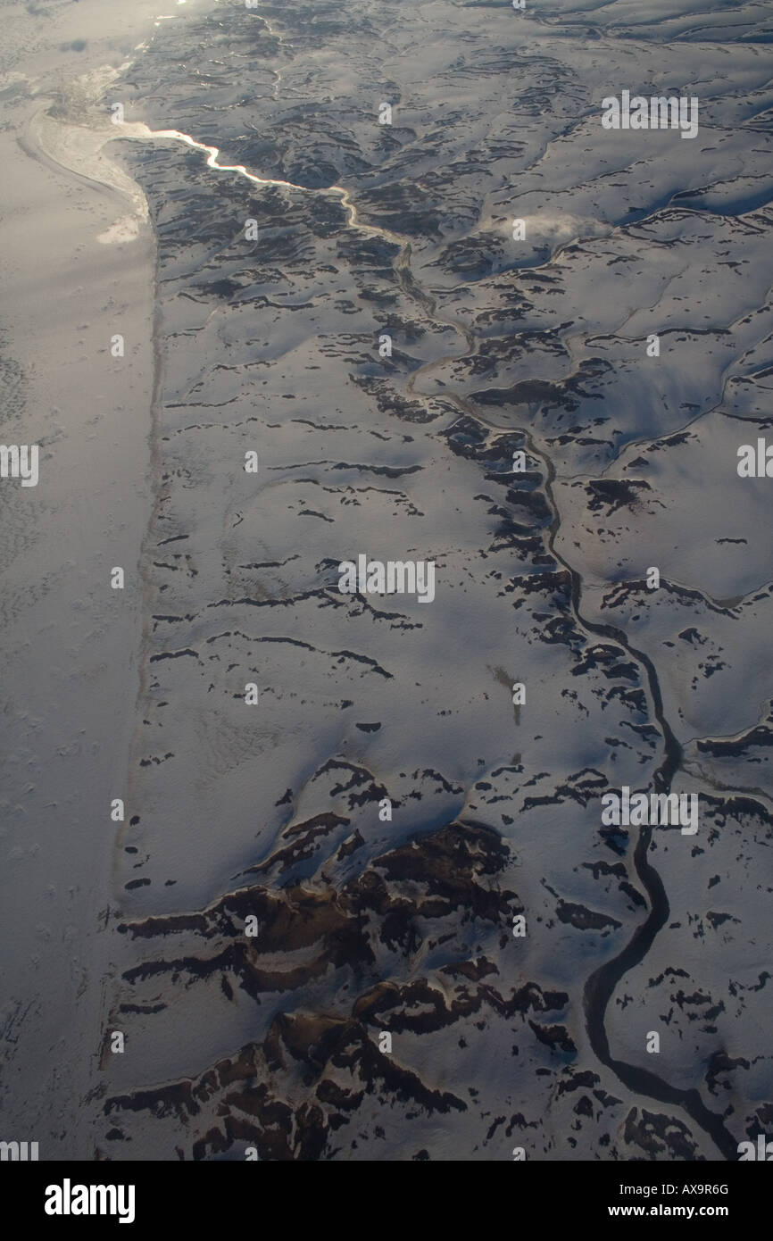 arial photograph of a river and river mouth in Greenland with snow ...