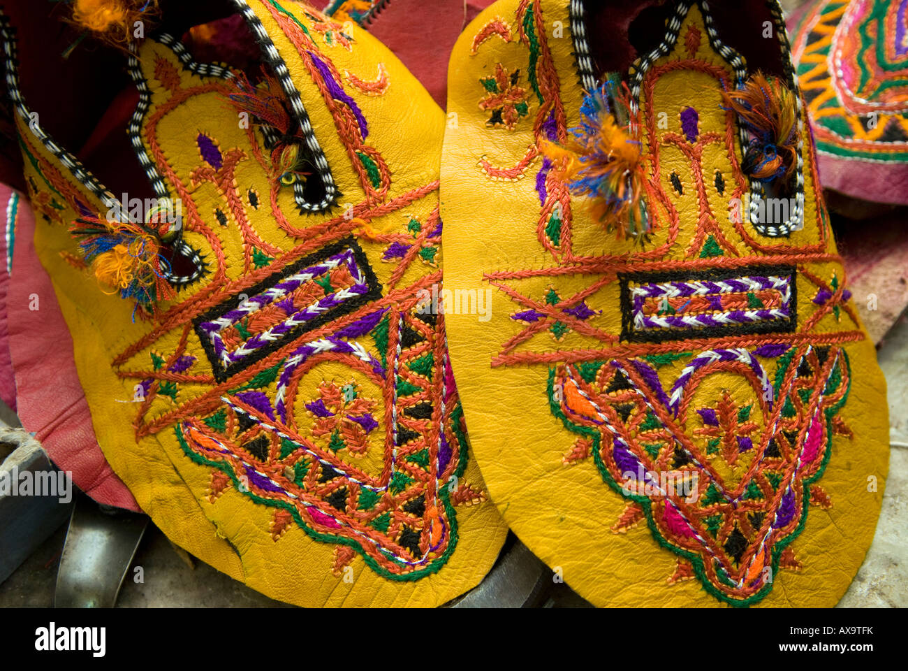 Traditional colourful shoes produced by the Ben Yedder shoe workshop ...