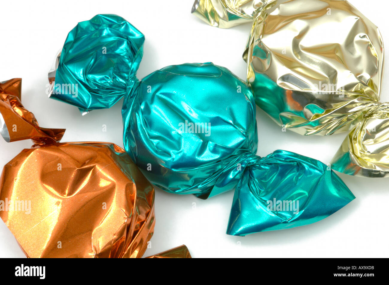 Colourful shiny paper wrapped toffee sweets on white background Stock ...
