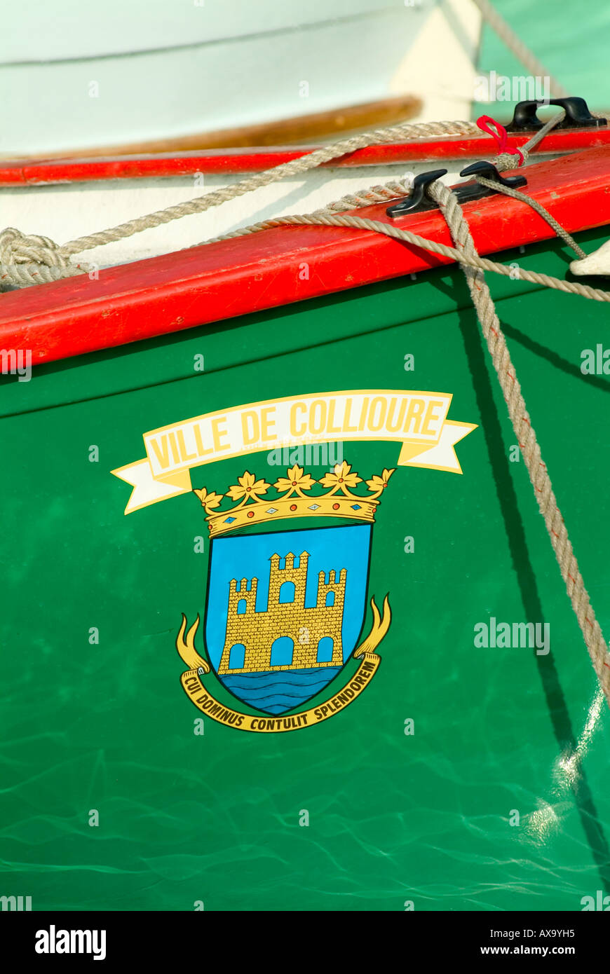 Brightly painted wooden fishing boat with the town crest of Collioure ...