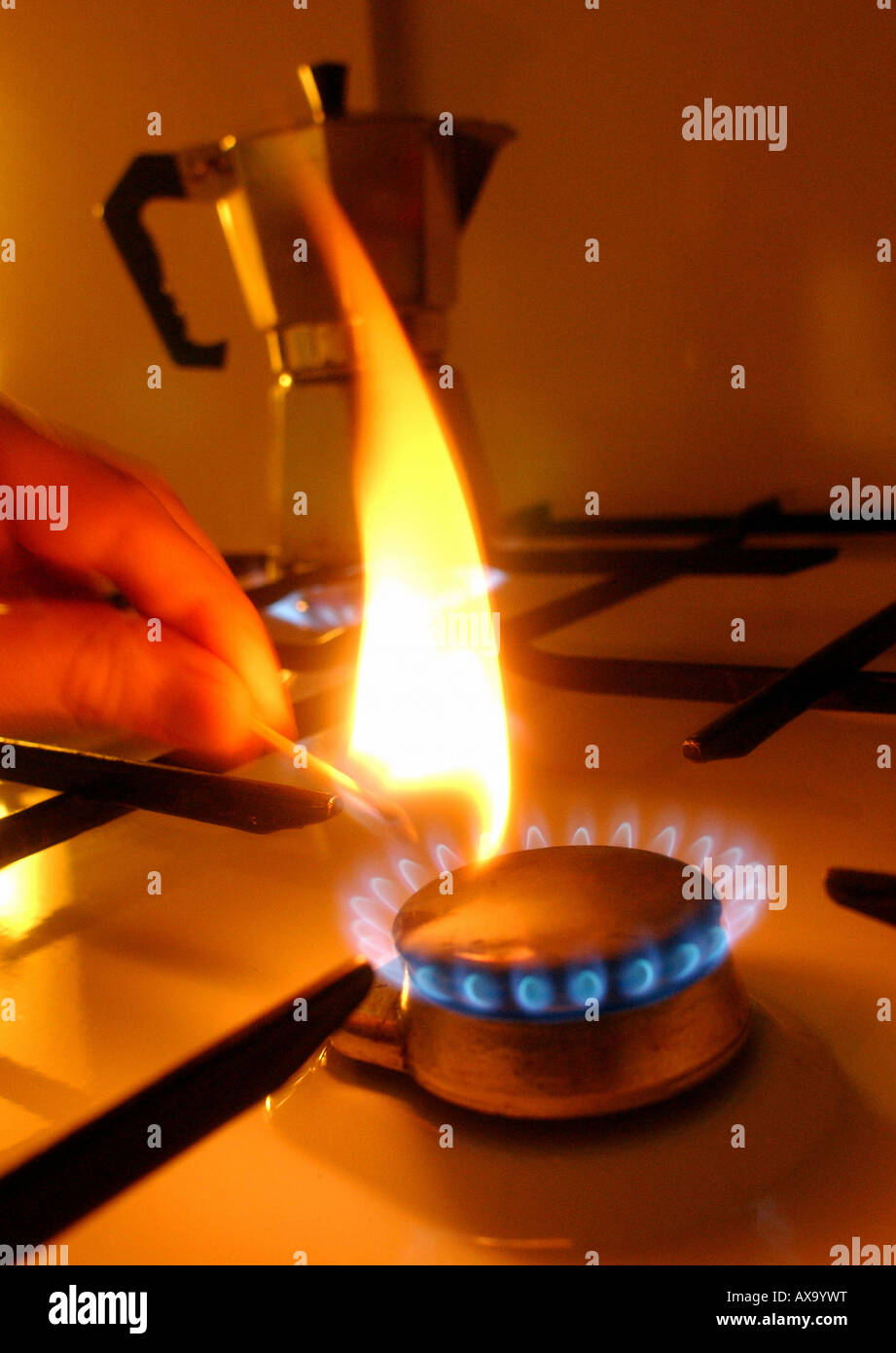Hand lighting a burner with a match Stock Photo - Alamy