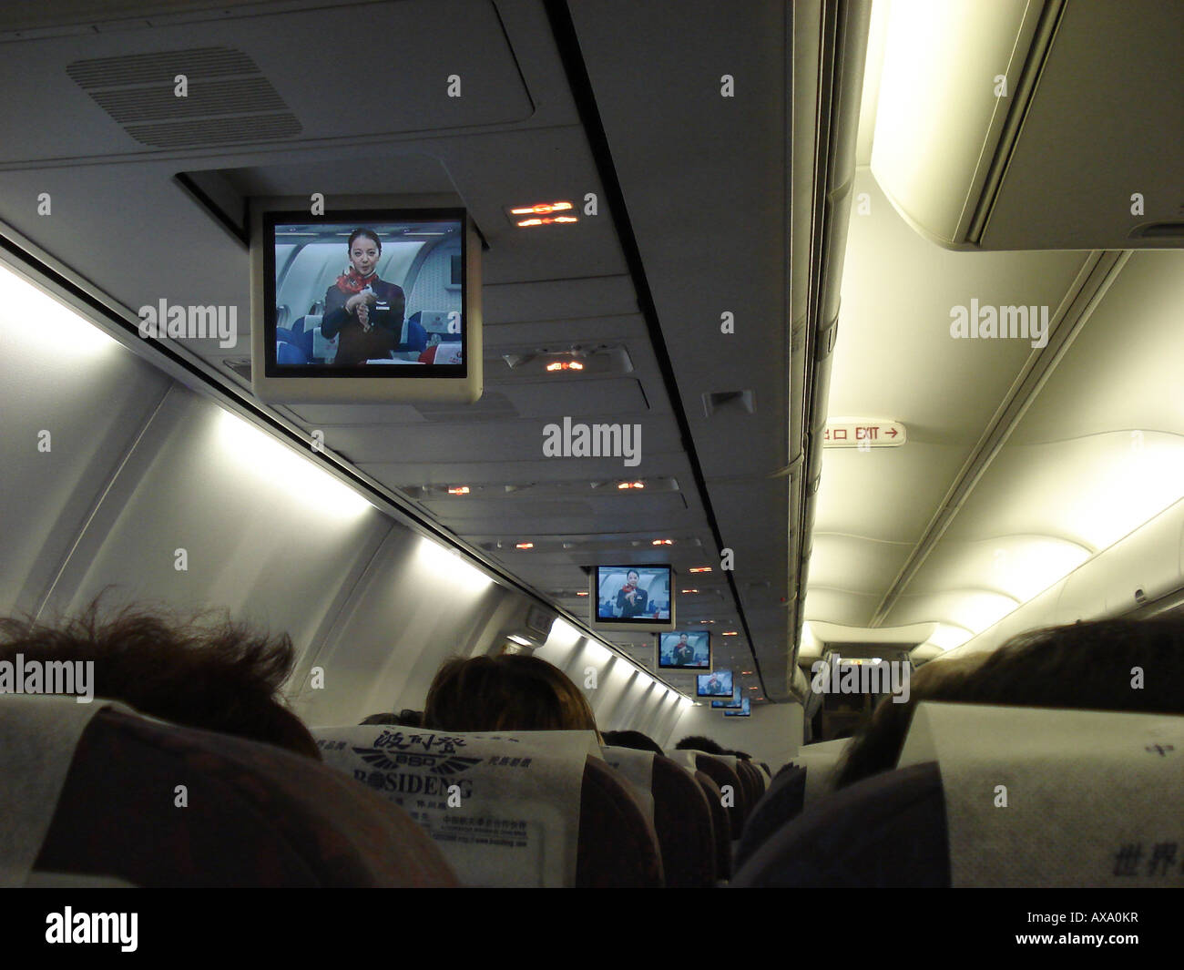 Aircraft cabin in China with tv going through safety procedures Stock ...