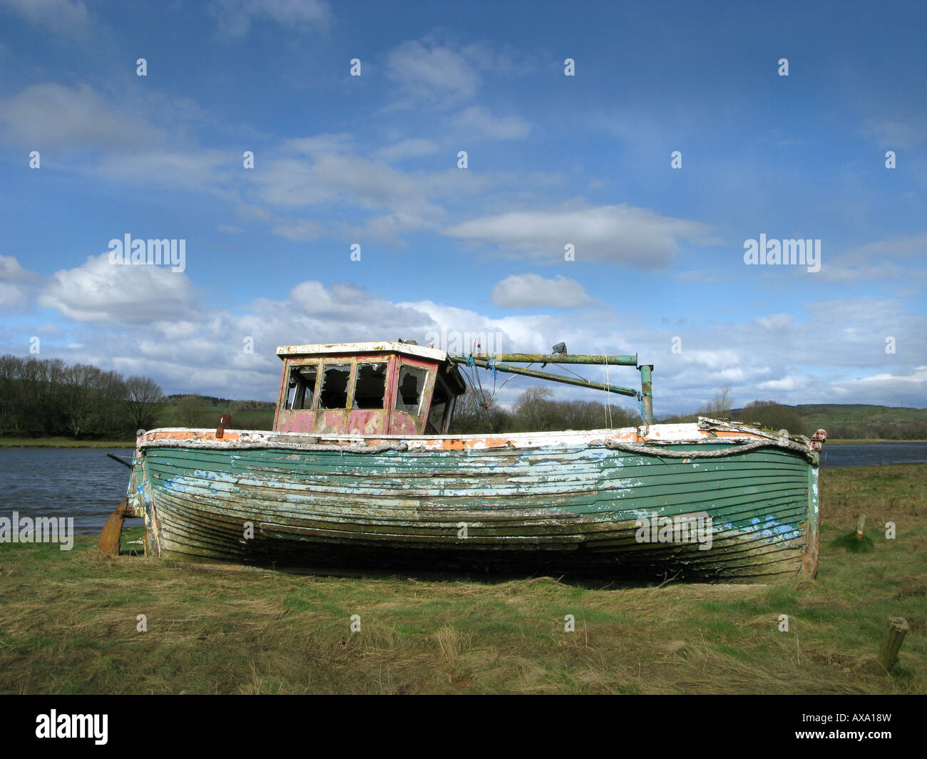 A derelict wooden fishing boat - 'Loch Ryan Lady' rotting on the banks ...