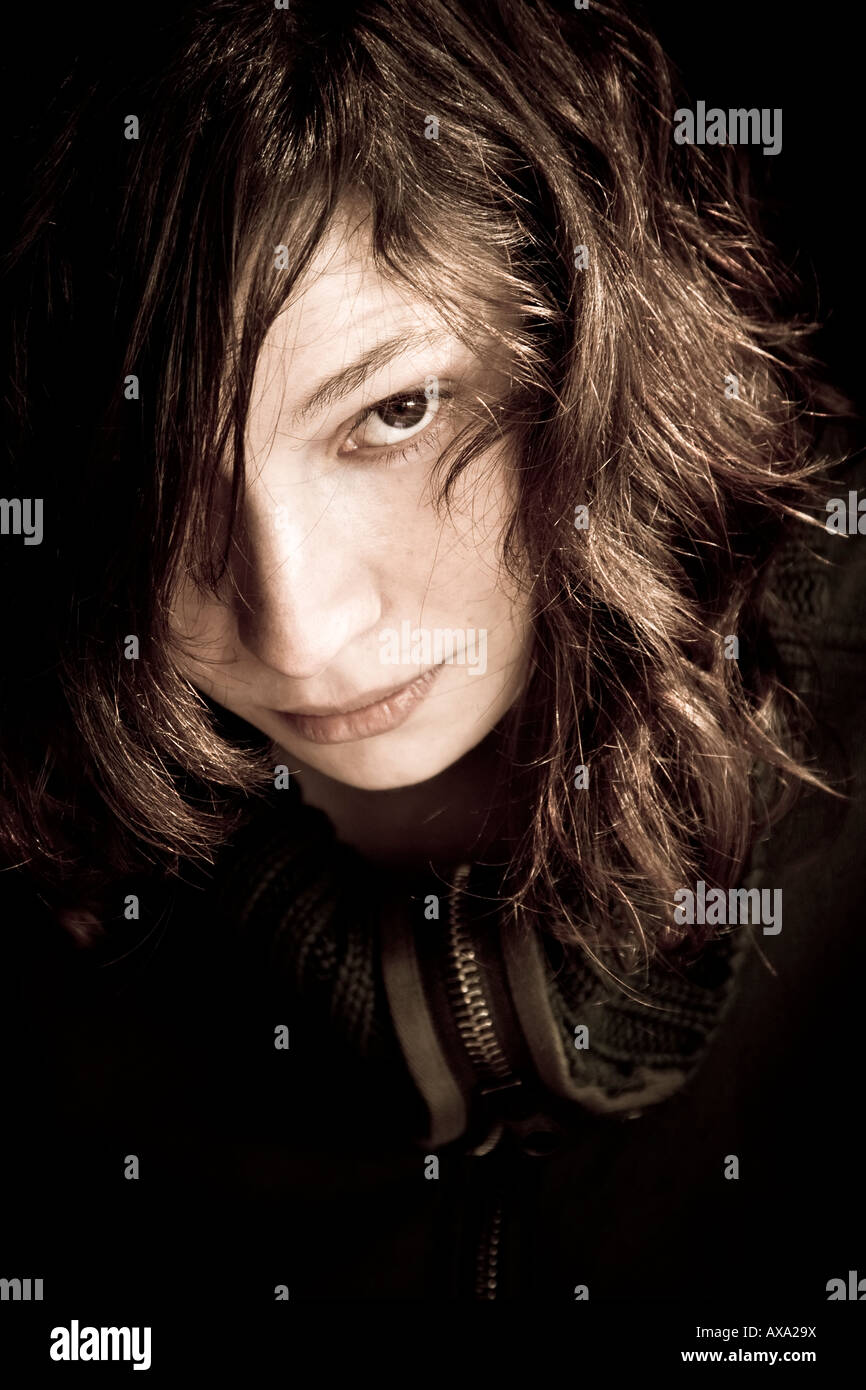 Dark portrait of woman with evil expression Stock Photo - Alamy