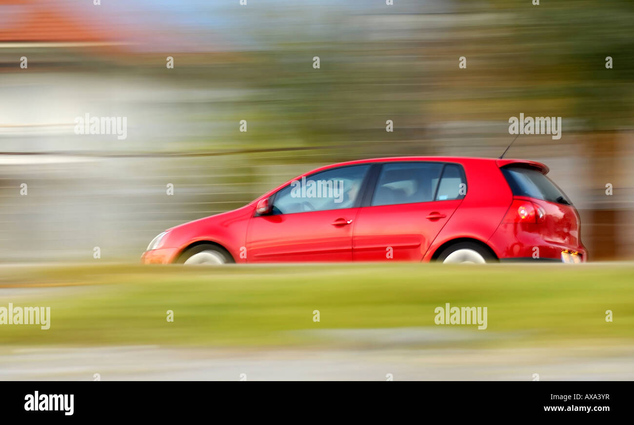 Fast moving red car Stock Photo - Alamy