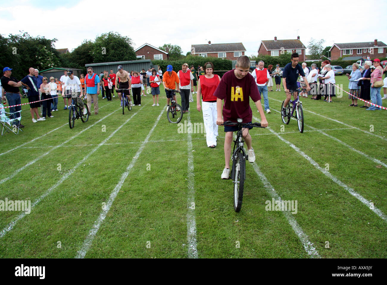 A slow bicycle race, the lad at the front is losing Stock Photo - Alamy