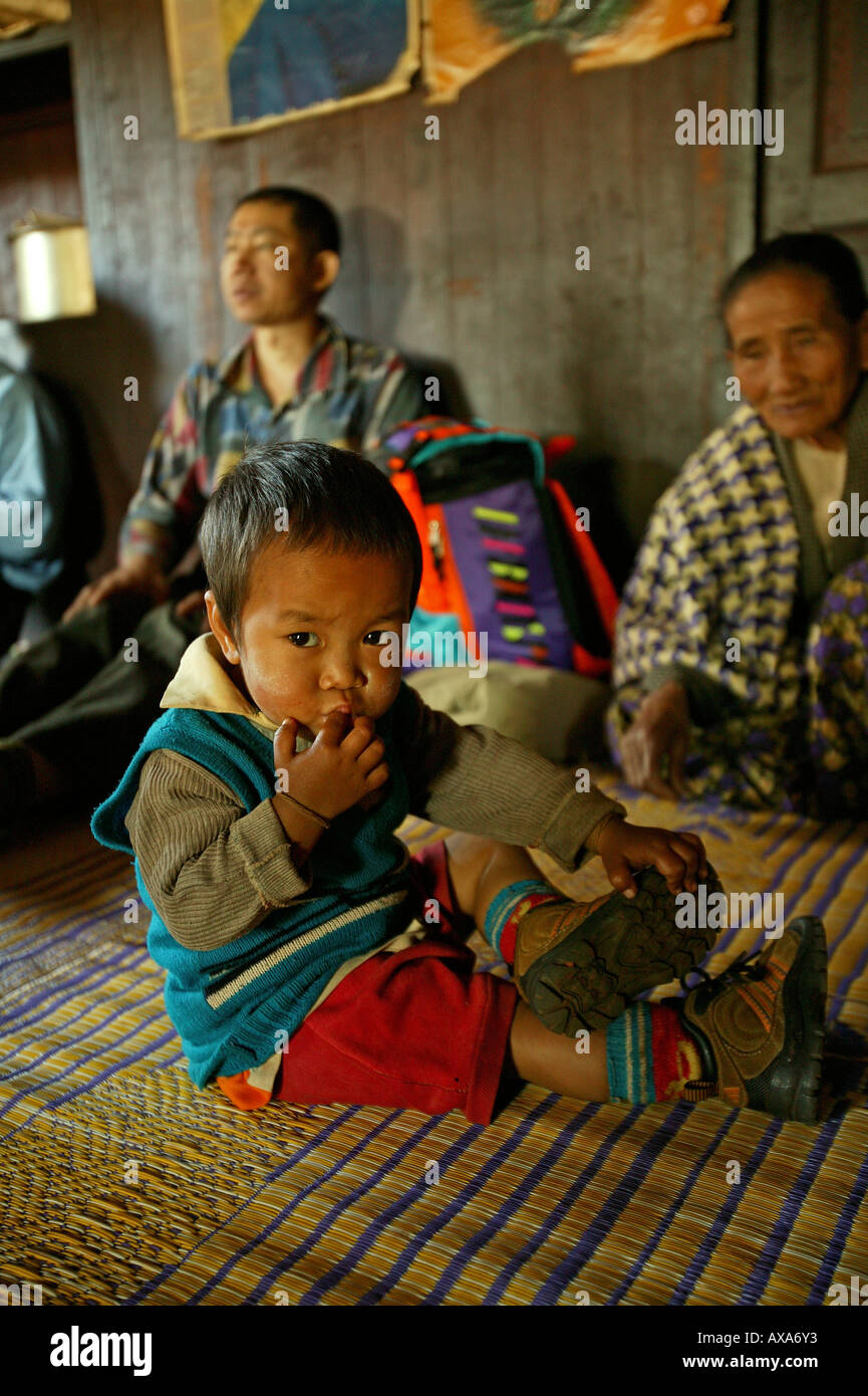 Burmese child sitting on floor with family, Burma, Myanmar Stock Photo ...