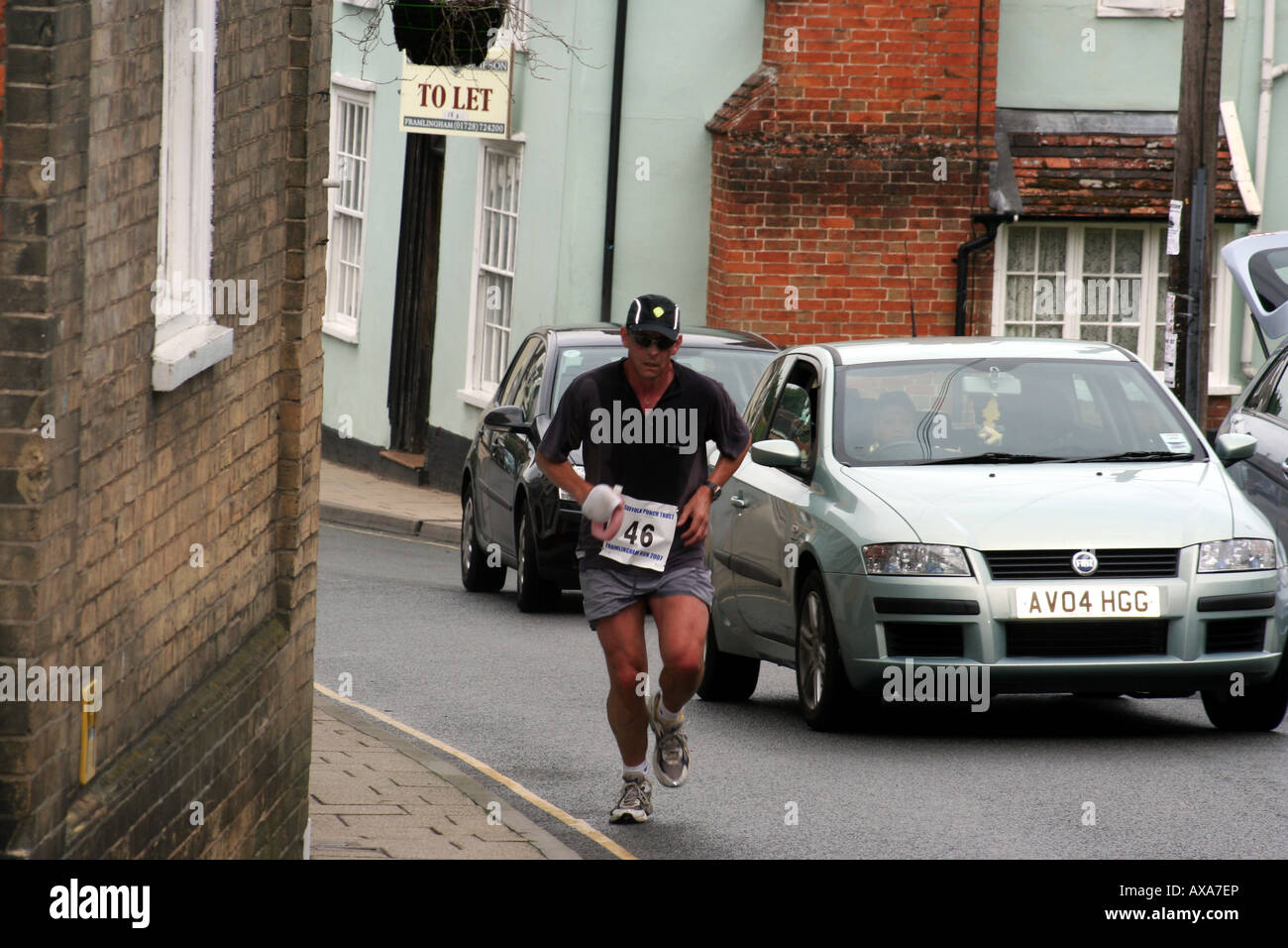 Half marathon runner in traffic Stock Photo - Alamy