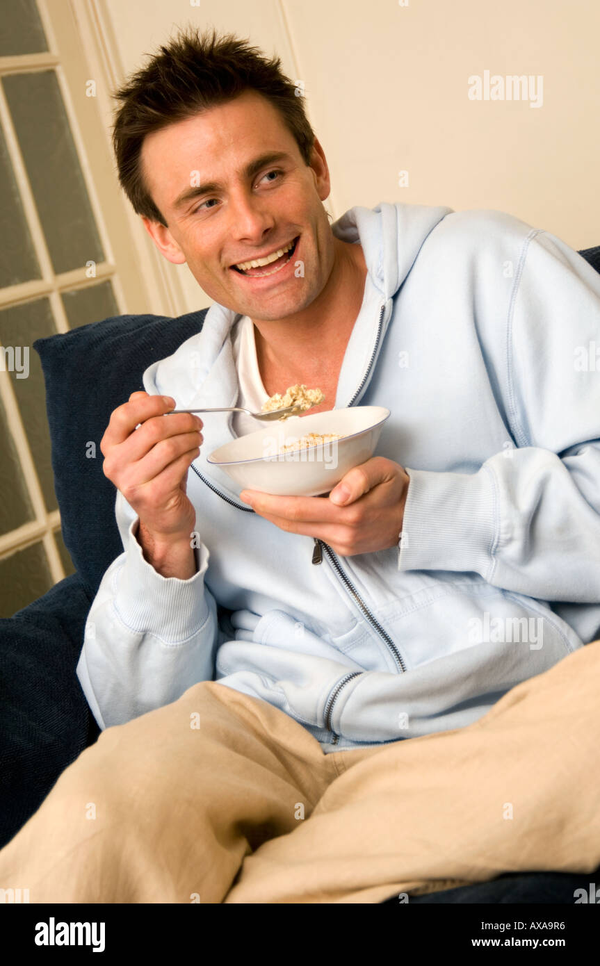 Man eating cereal on sofa hi-res stock photography and images - Alamy