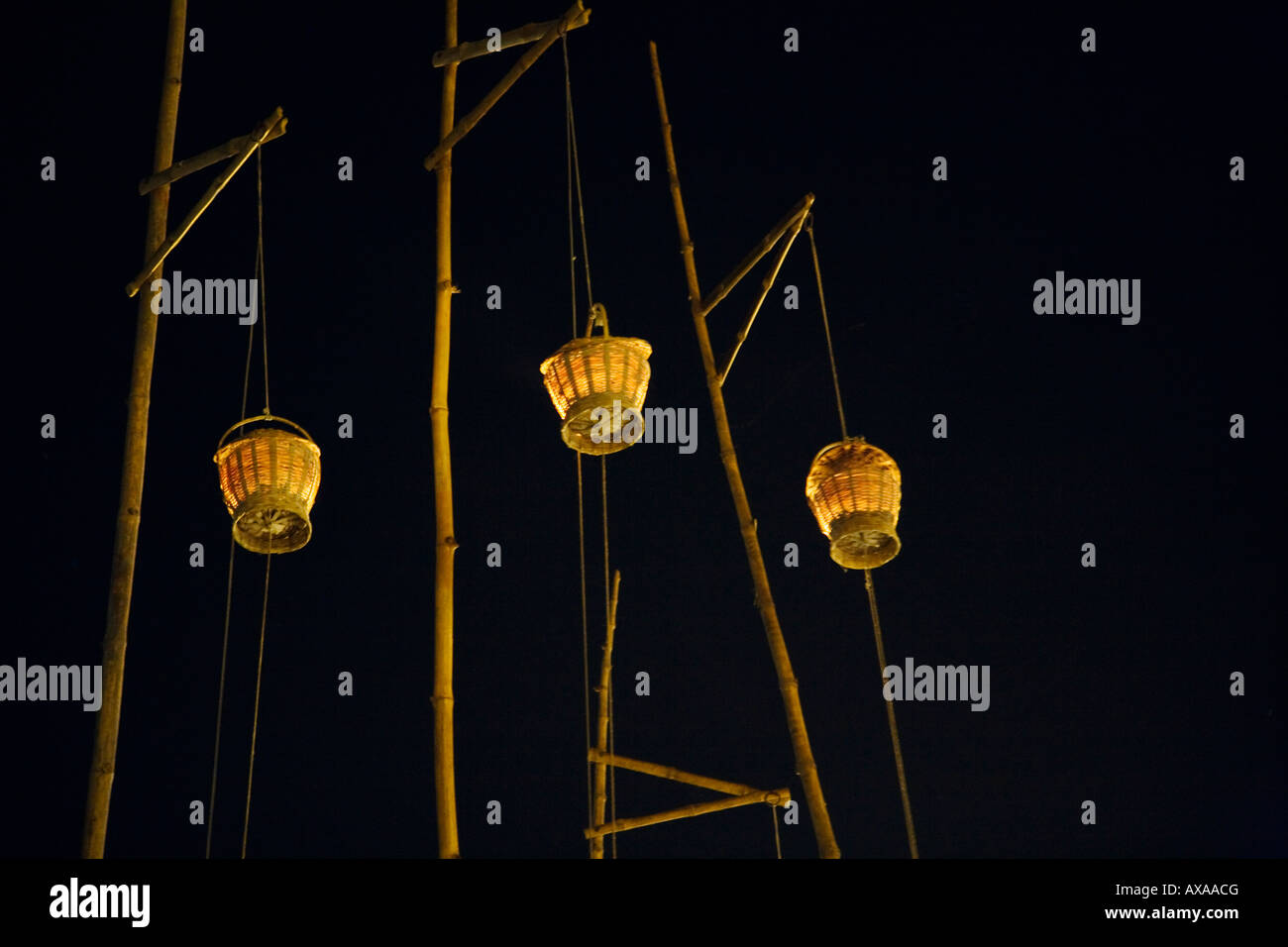 Night view of lights on bamboo sticks on the river bank of the Ganges ...