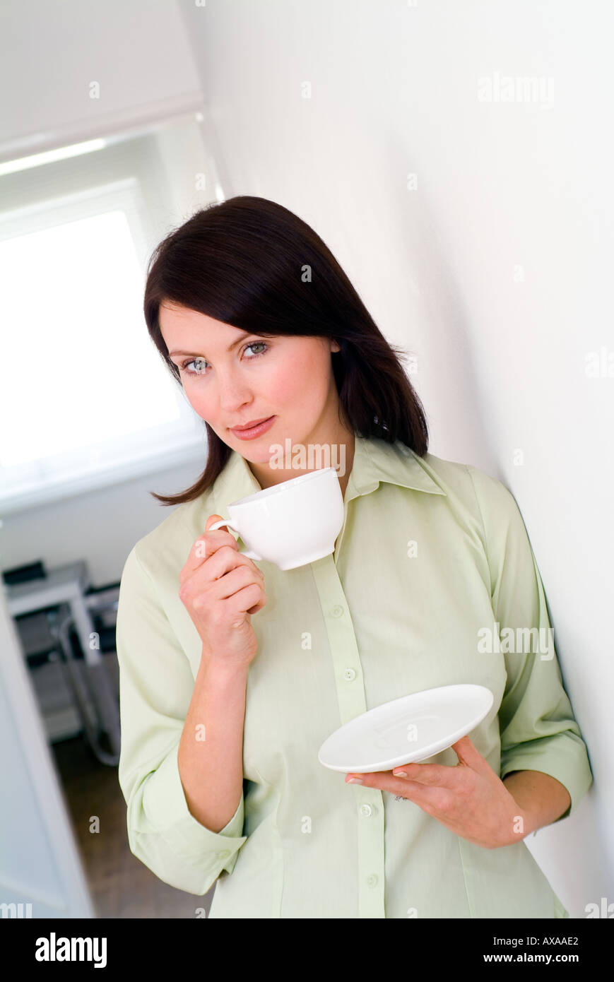 Thoughtful girl holding drink hi-res stock photography and images - Alamy