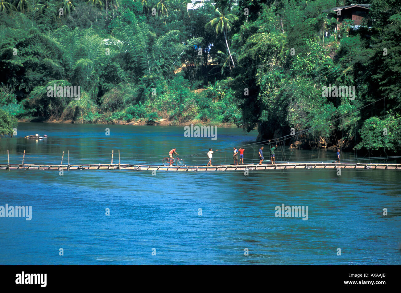 People crossing rope bridge over Kwae Yai river-, Kanchanaburi Thailand ...