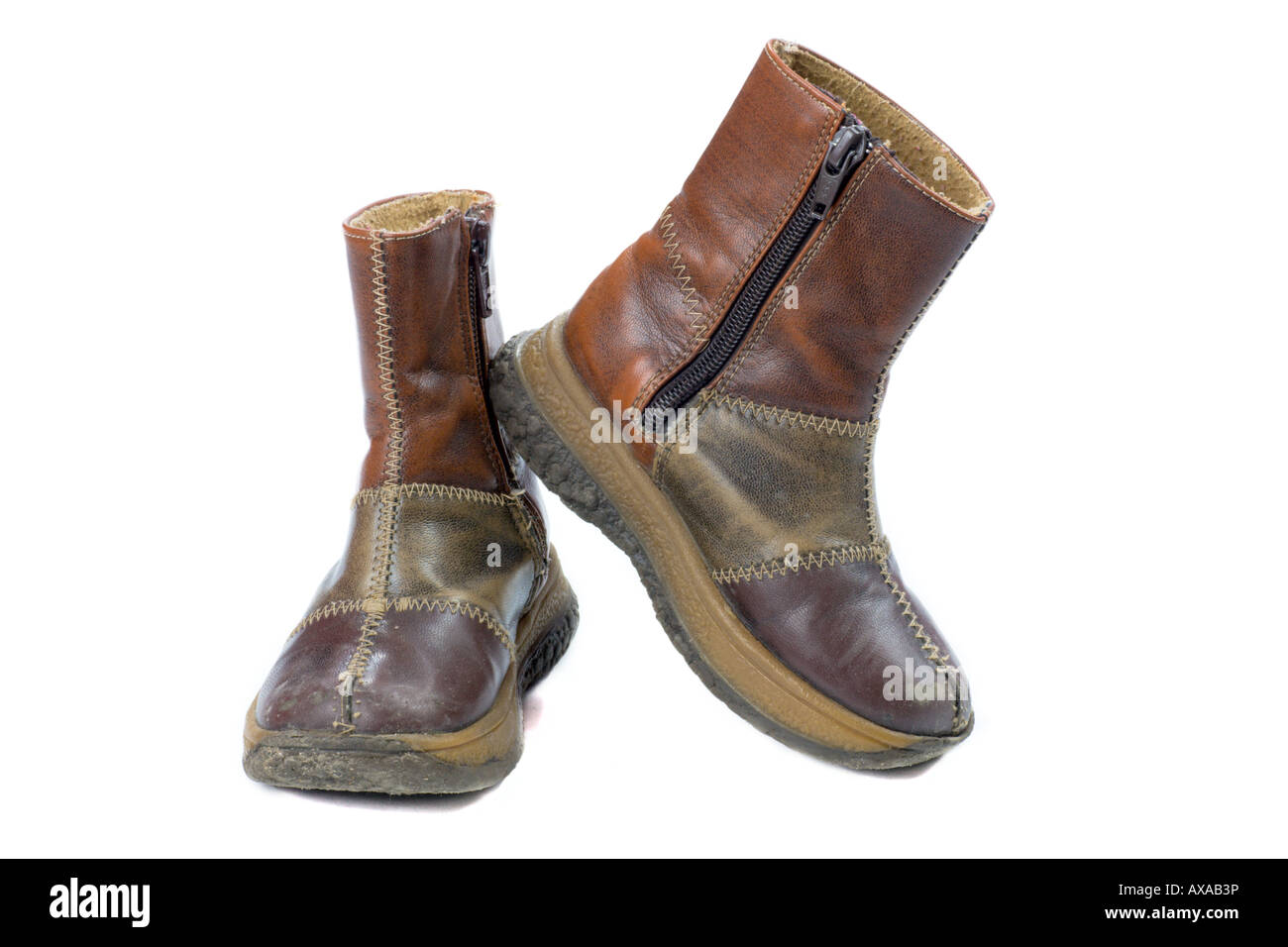 Used old child shoes made of pieces of leather isolated on white Stock ...