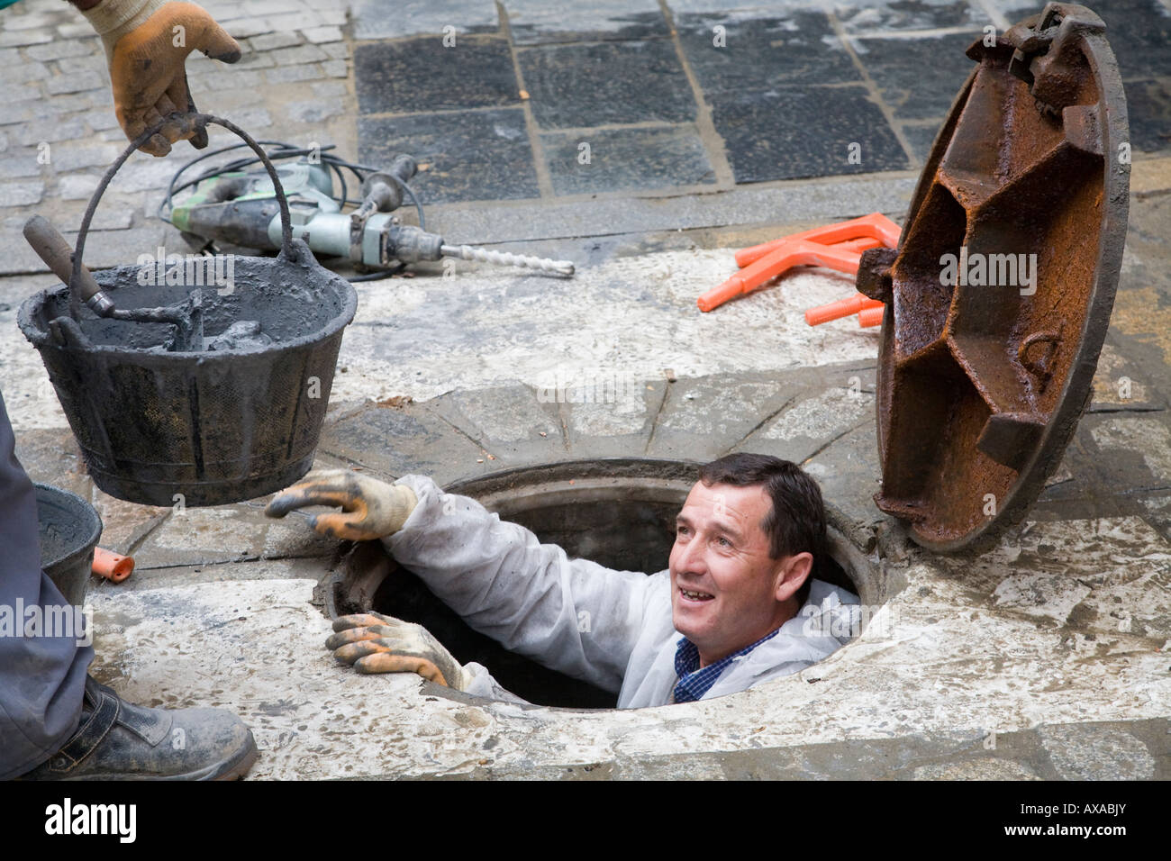 Sewer worker inside a manhole, Seville, Spain Stock Photo - Alamy