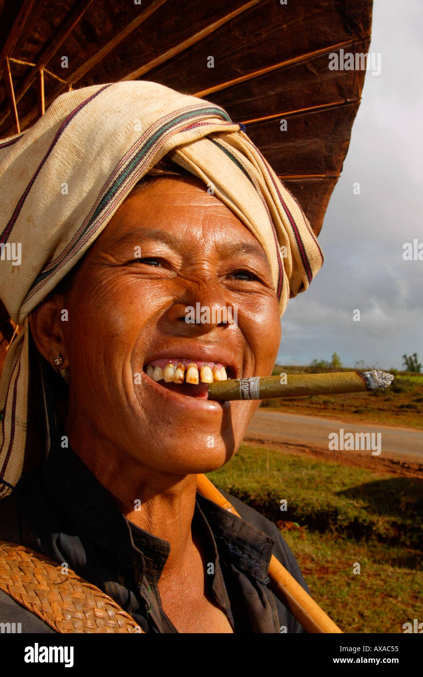 Woman agricultural worker smoking a green cheroot in Burma Myanmar ...