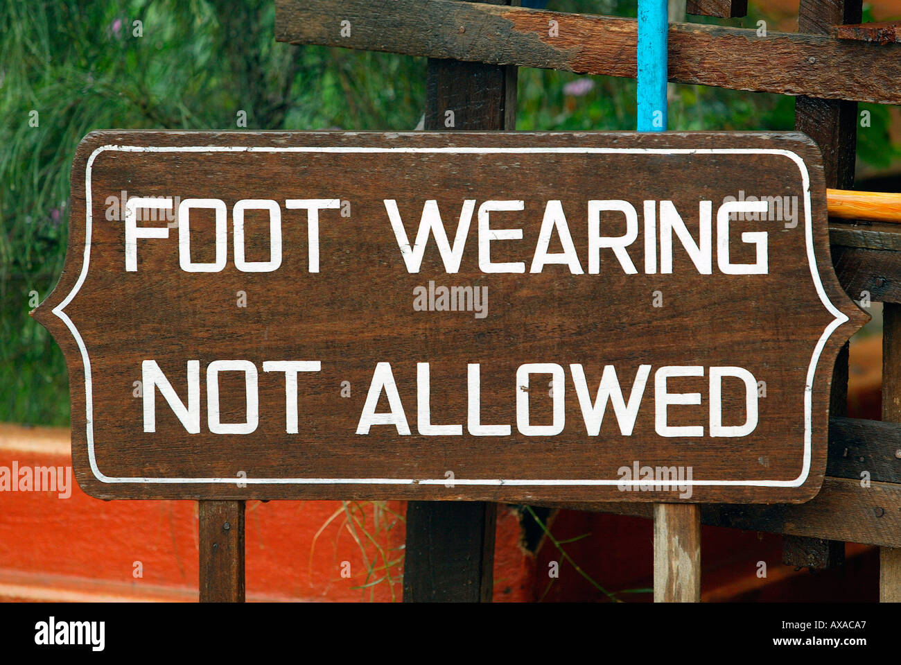 Foot Wearing Not Allowed amusing wooden sign in Burma Stock Photo - Alamy