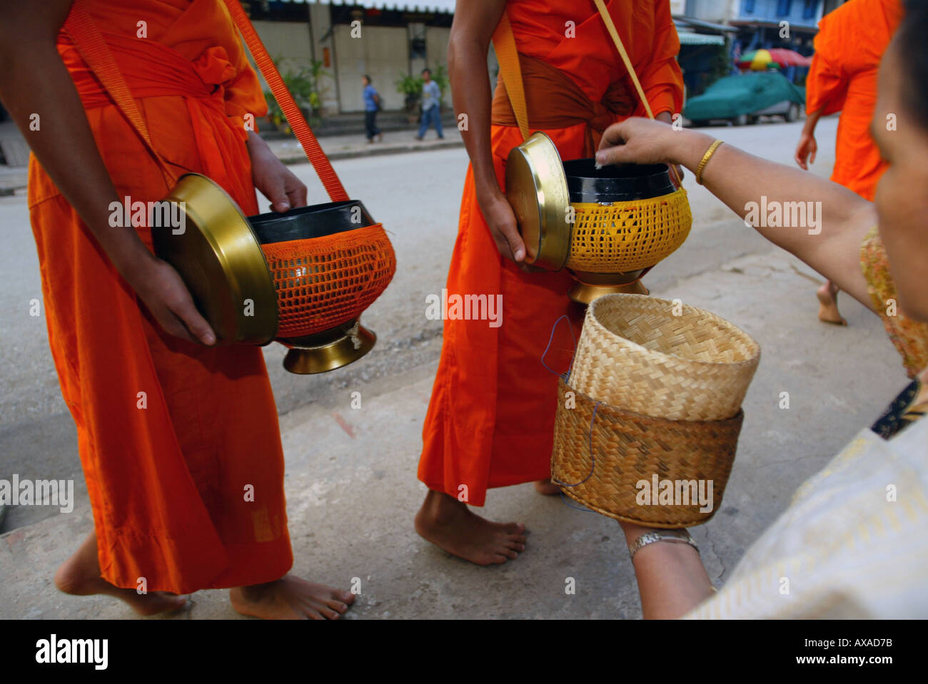 Monks line up to receive daily rice from woman Luang Prabang Laos Stock ...