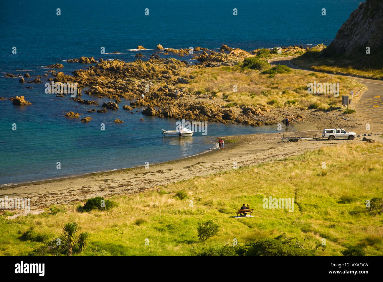 Launching small boat in rocky bay Stock Photo - Alamy