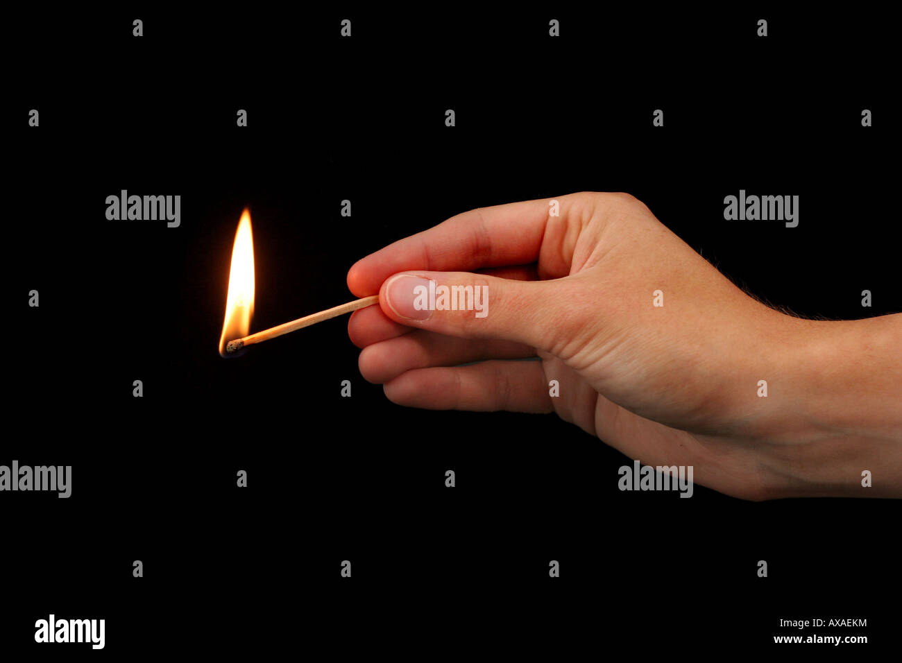 A hand holding a lit match Stock Photo - Alamy