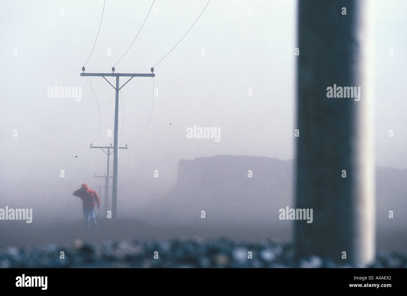 Pedestrian covers his face from sand storm, Iceland Stock Photo - Alamy