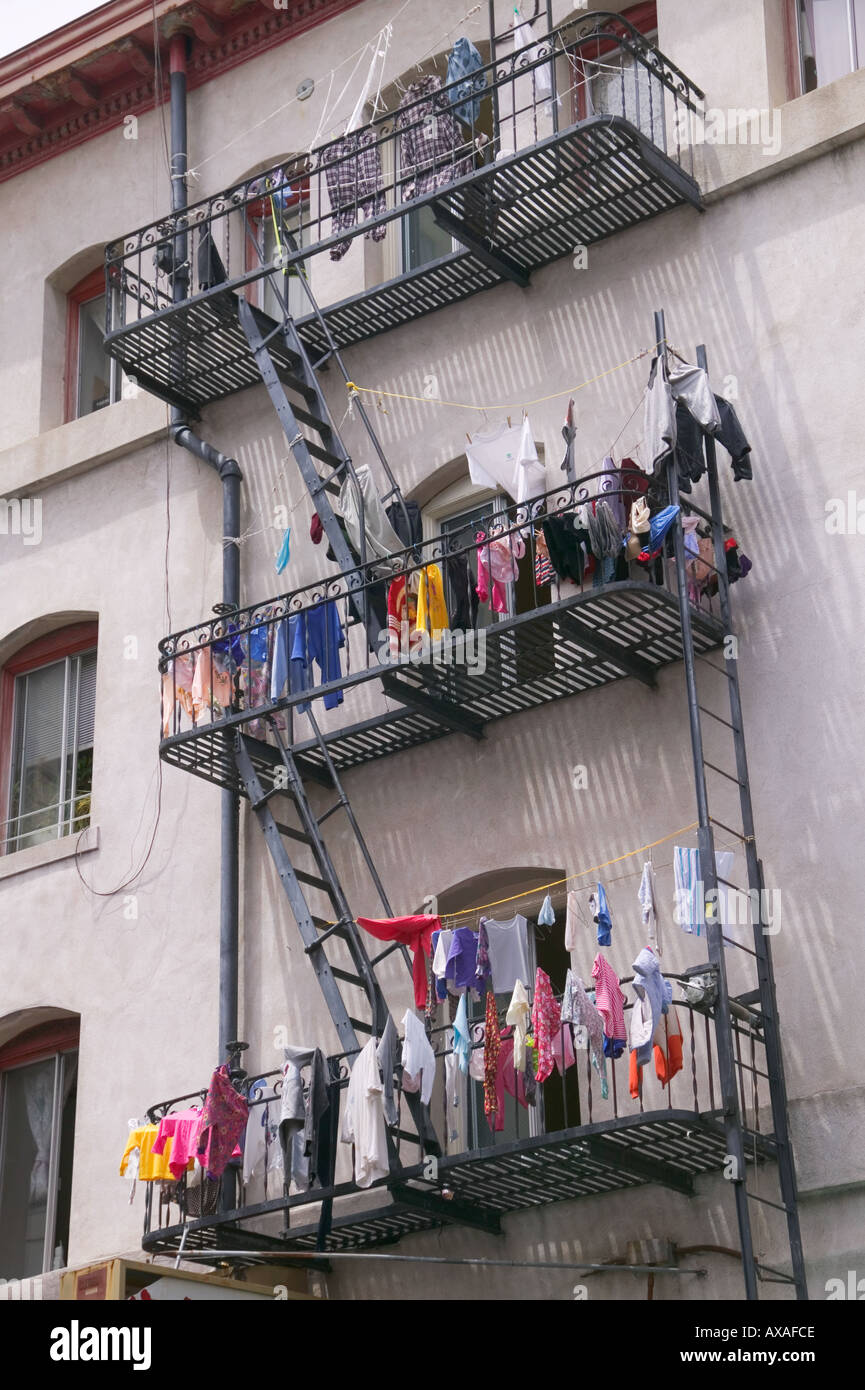 Clothes hanging from fire escape Stock Photo - Alamy