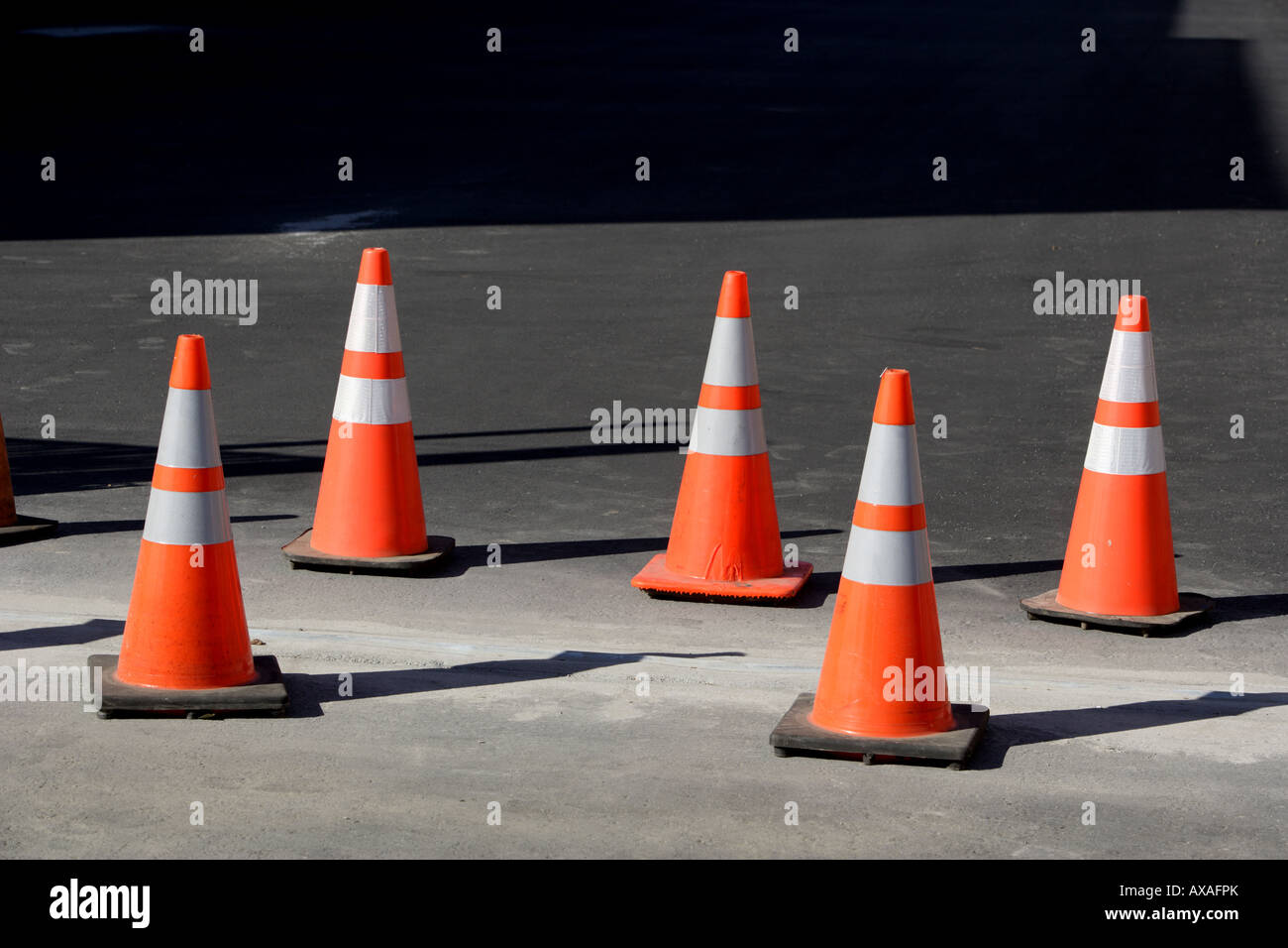 A row of orange cones warns of danger ahead Stock Photo - Alamy