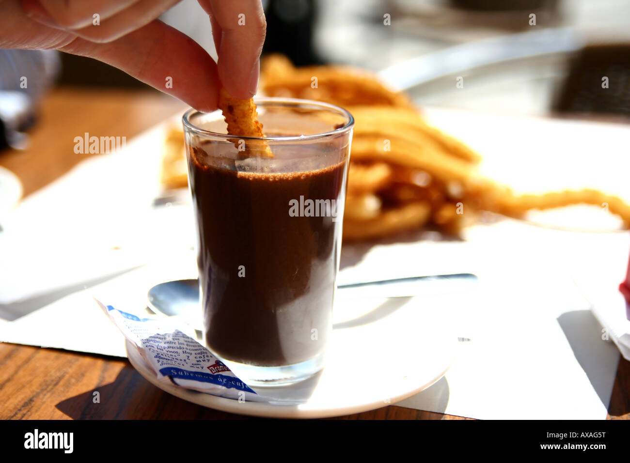 Having "churros" and chocolate for breakfast at a Spanish café Stock ...