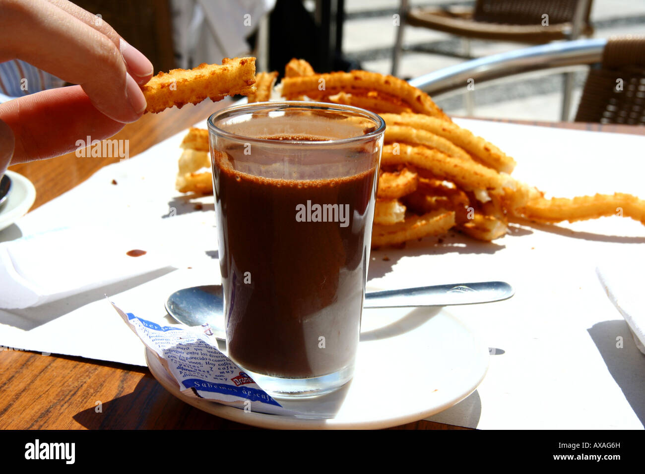 Having "churros" and chocolate for breakfast at a Spanish café Stock ...