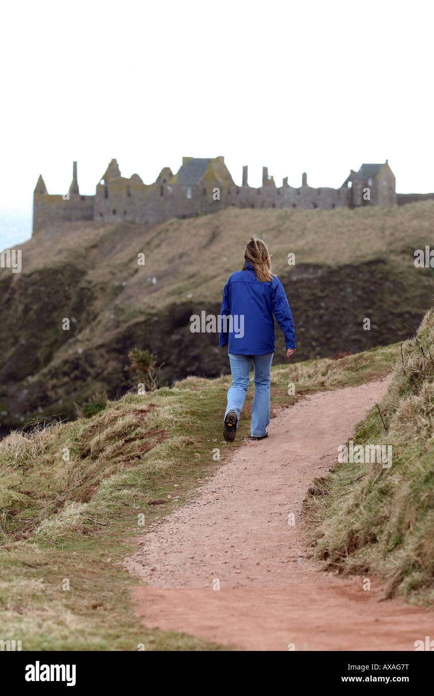Walking on the clifftop path toward Dunnottar Castle near Stonehaven ...