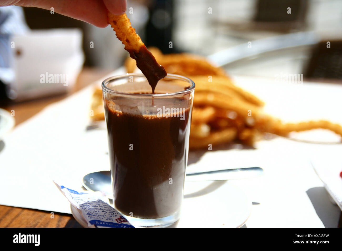 Having "churros" and chocolate for breakfast at a Spanish café Stock ...