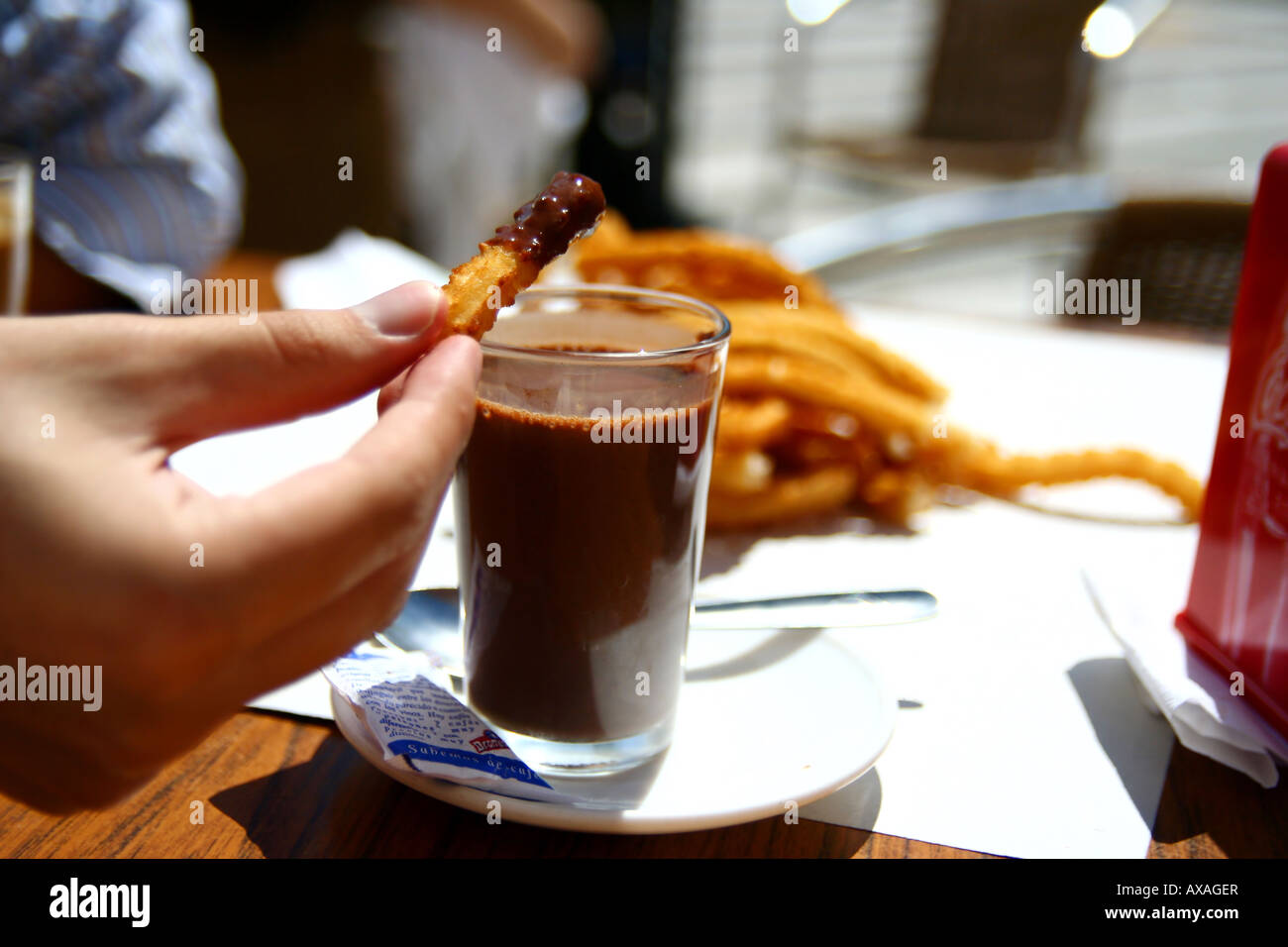 Having "churros" and chocolate for breakfast at a Spanish café Stock ...