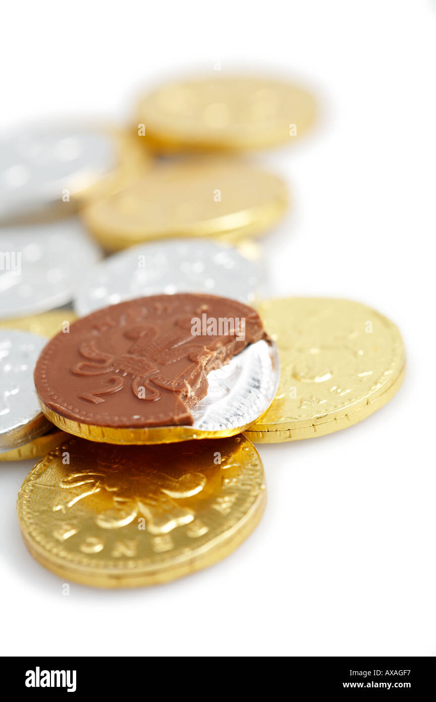 Chocolate money eating your savings Stock Photo - Alamy