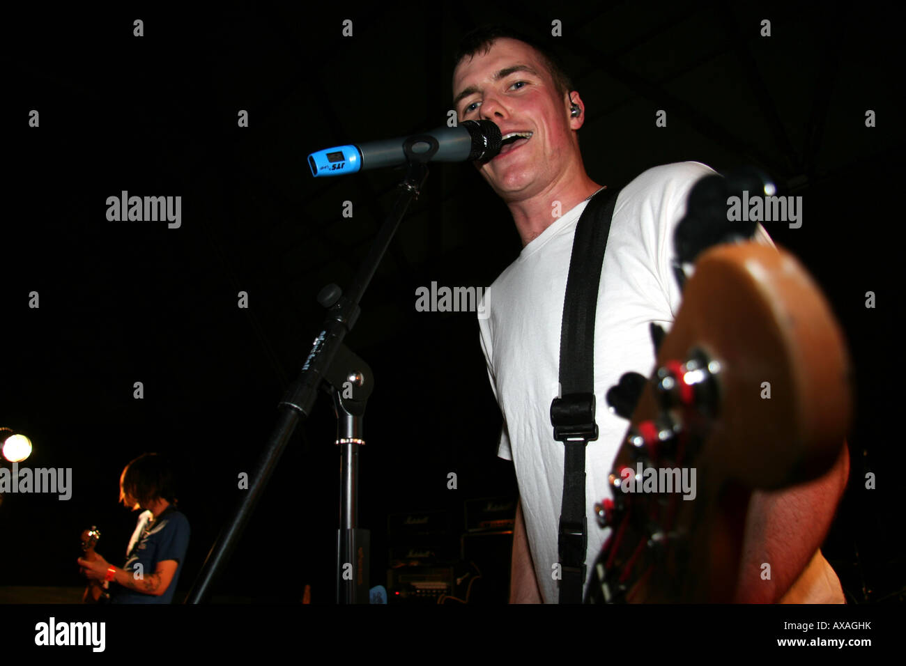Singing rock bass guitarist looks at the camera Stock Photo - Alamy