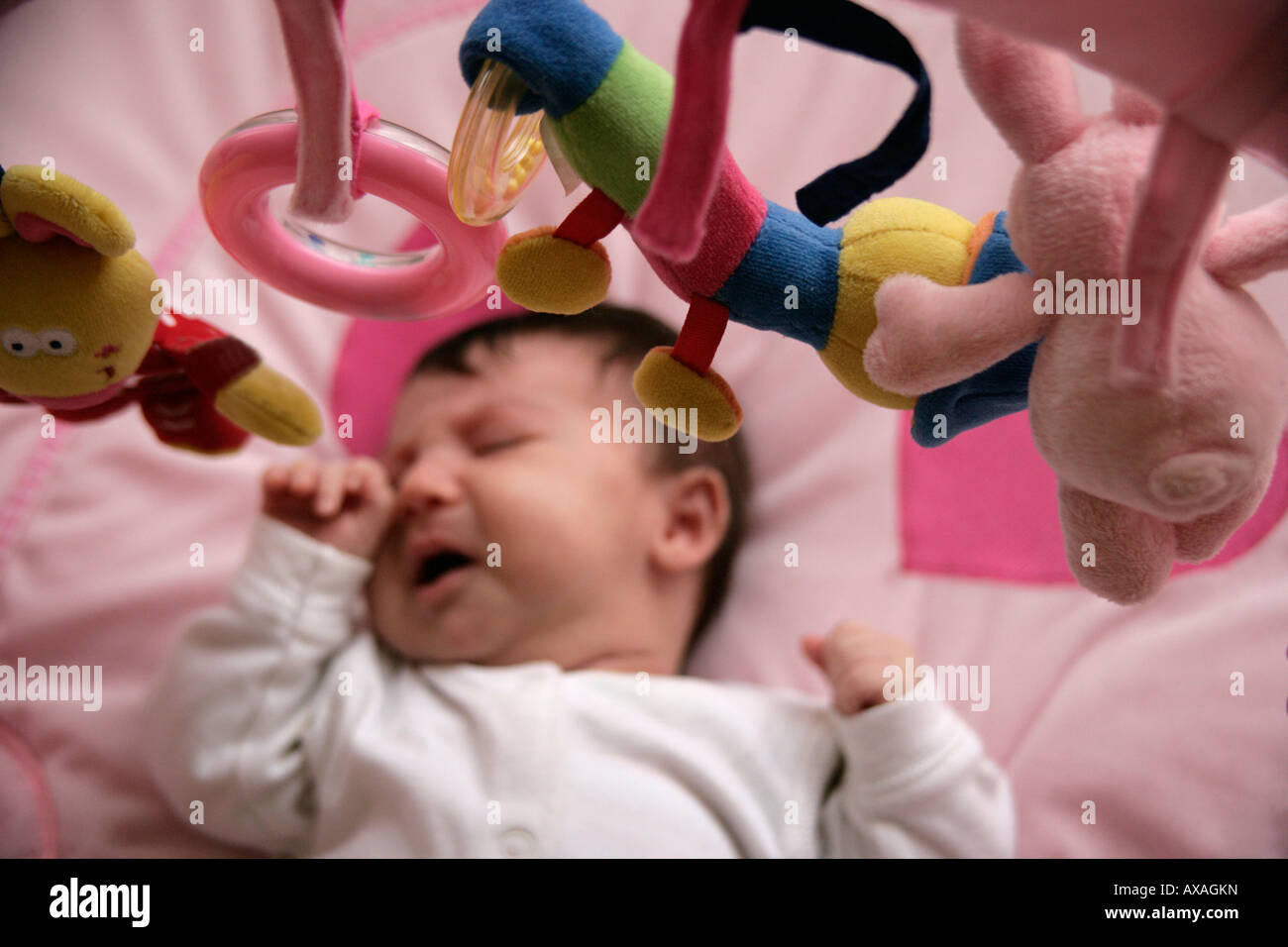 One month old crying baby on baby gym Stock Photo - Alamy