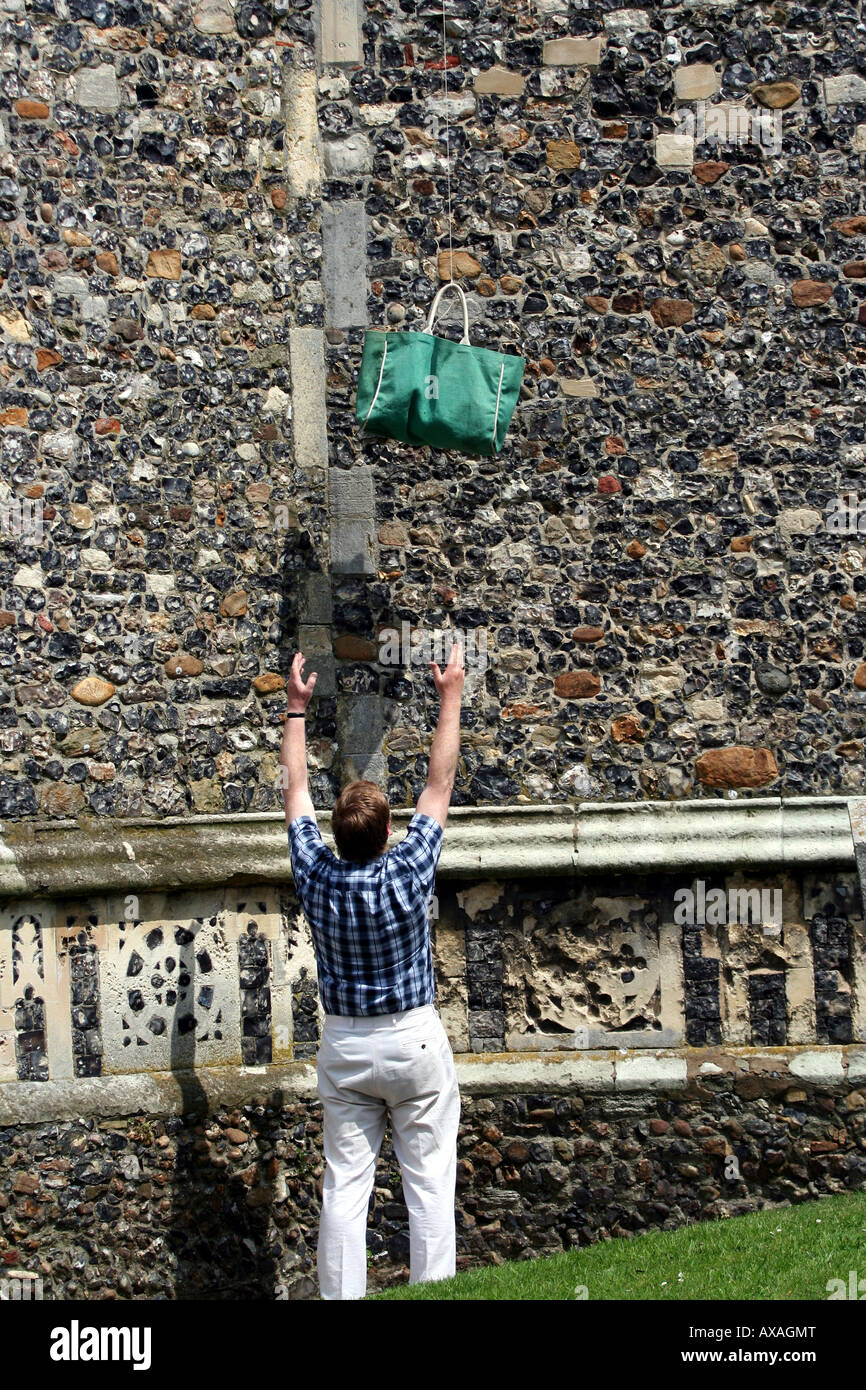 Man sees a bag on a string on its way Stock Photo - Alamy