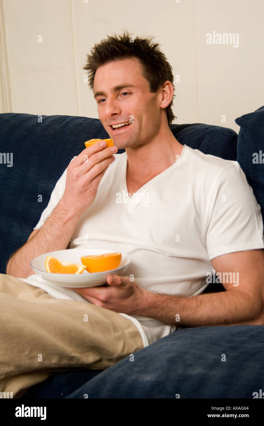 man eating oranges Stock Photo - Alamy