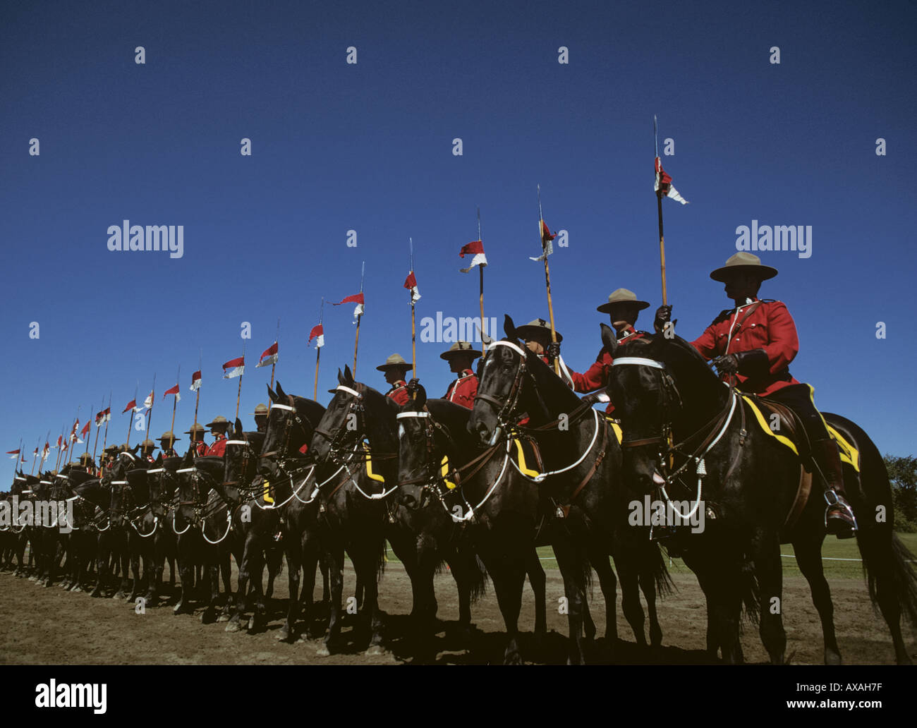 Mounties in red ceremonial uniforms lined up on their regulation black ...