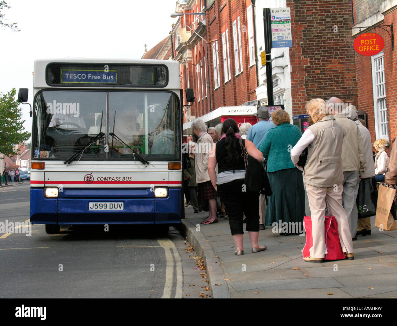 people queueing and getting on a Compass free Tesco bus in Chichester ...