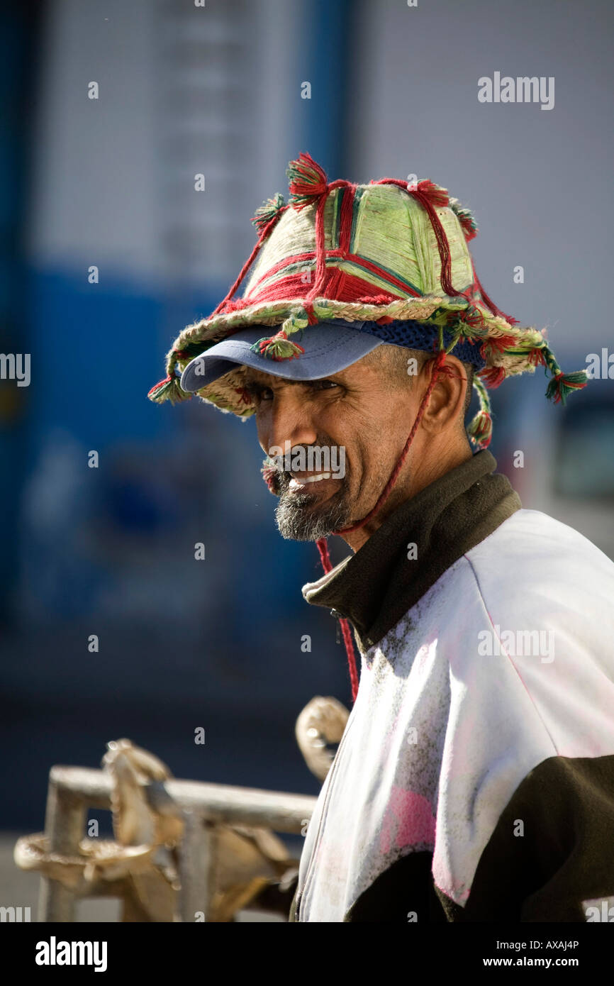 Man with beard wearing decorated hat smiling. Agadir street, Morocco ...