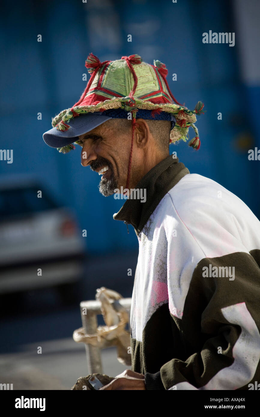 Man with beard wearing decorated hat smiling. Agadir street, Morocco ...