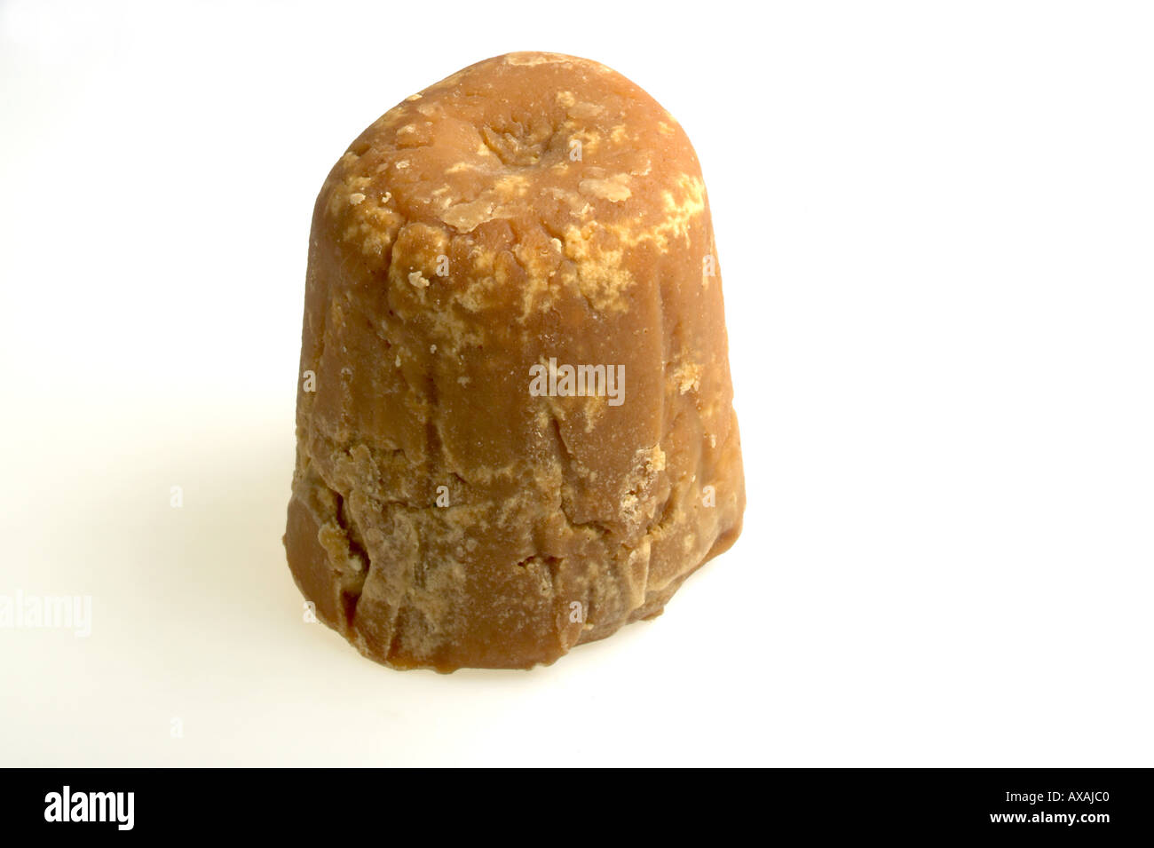 One large piece of moulded sweet Jaggery gur Stock Photo - Alamy