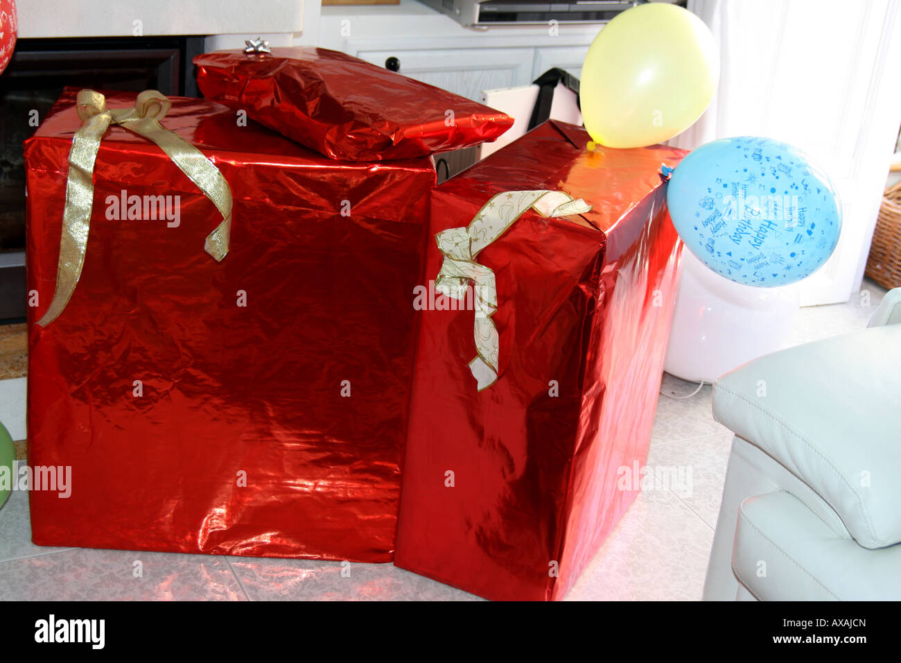 Big red present packages and colour balloons Stock Photo - Alamy