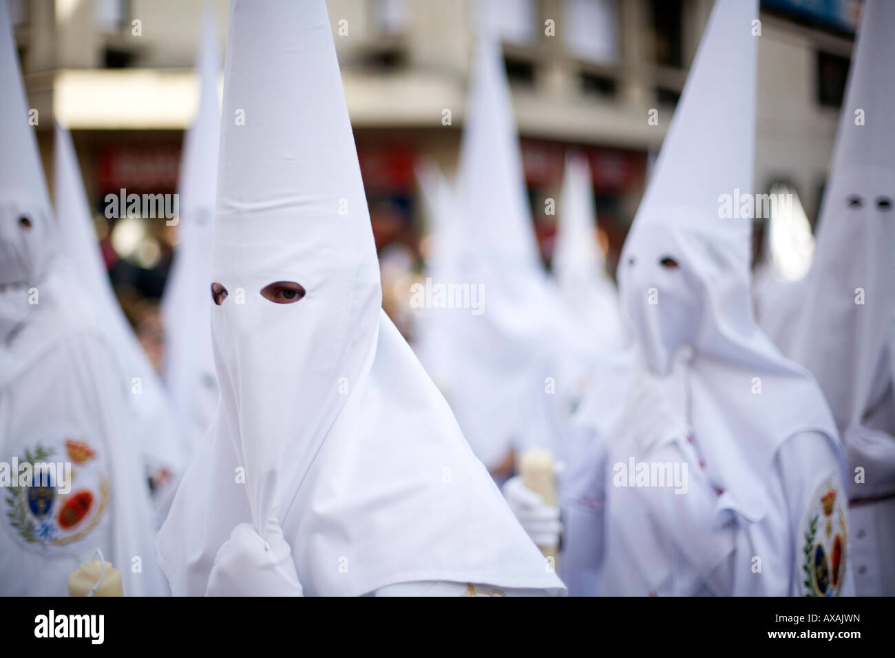 Group of hooded penitents, Palm Sunday, Seville, Spain Stock Photo - Alamy